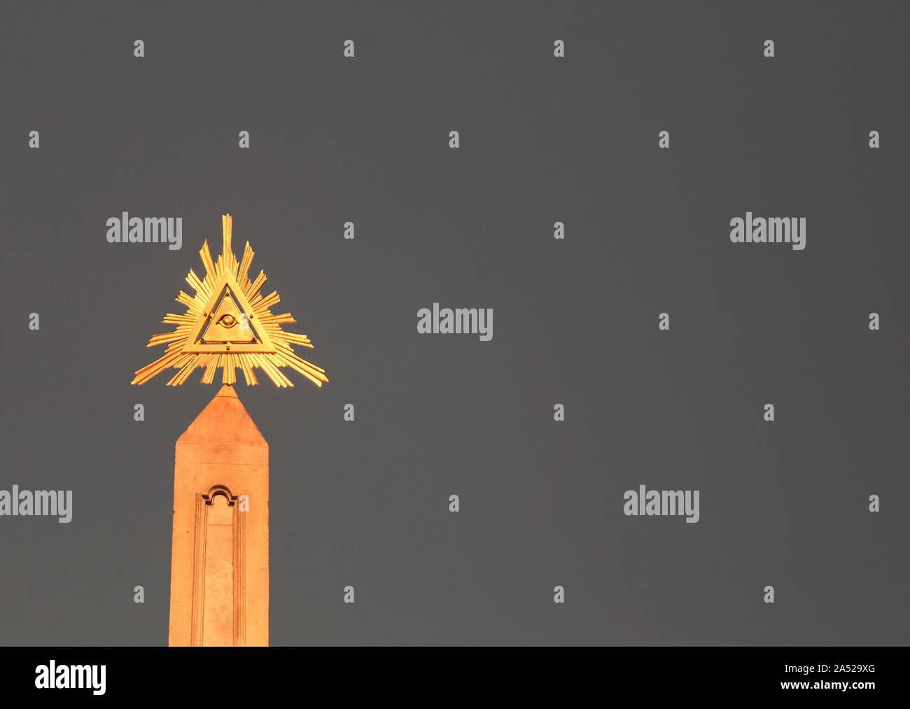 golden symbol of eye of providence on grey background Stock Photo - Alamy