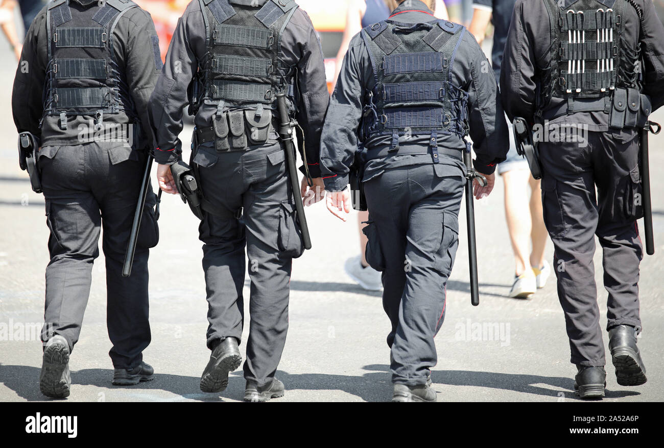 four policemen of special force unit patroling the city with bulletprof ...
