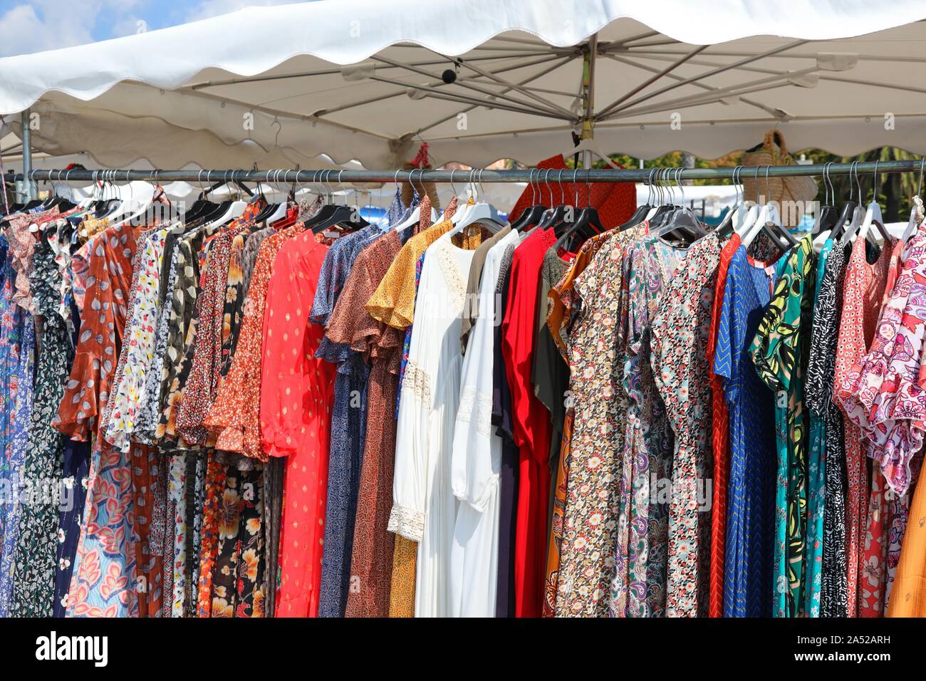 Stand of clothes at outdoor market in summer Stock Photo - Alamy