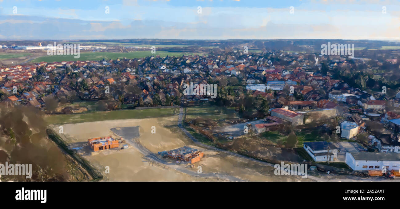 Aerial view of the edge of a growing village, followed by a new ...