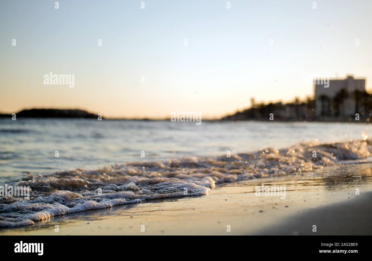 Beautiful waves on a calm and calm beach during sunset Stock Photo - Alamy