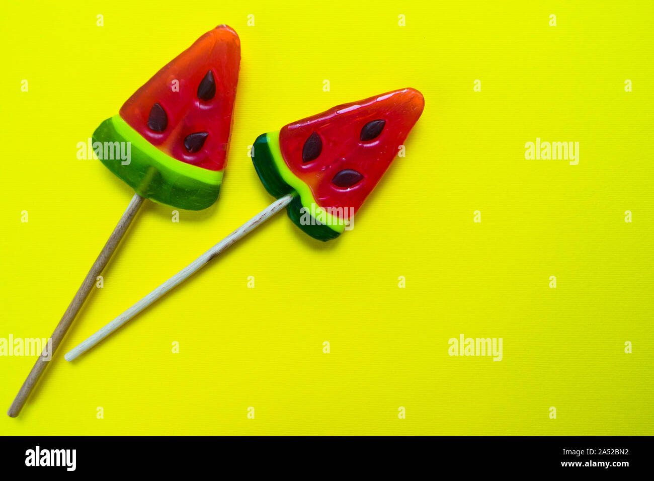 Watermelon wedge lollipop on bright yellow background. Copy space Stock ...