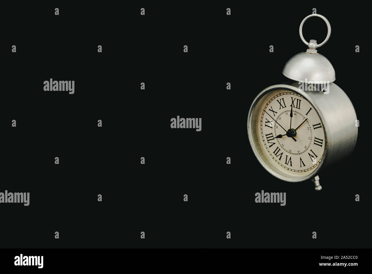 Classic and vintage matt gray alarm clock, marking eight o'clock, on a ...