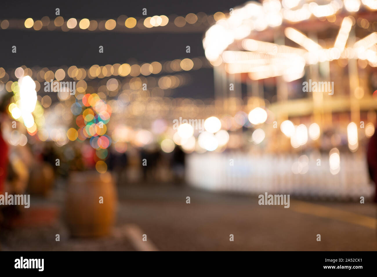Carousel with burning lights in evening, blurred image Stock Photo - Alamy