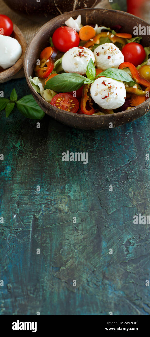Mixed salad with mozzarella in coconut bowls close up Stock Photo - Alamy