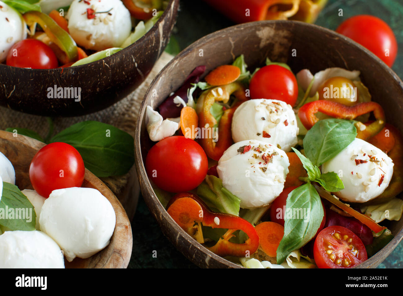 Mixed salad with mozzarella in coconut bowls close up Stock Photo - Alamy