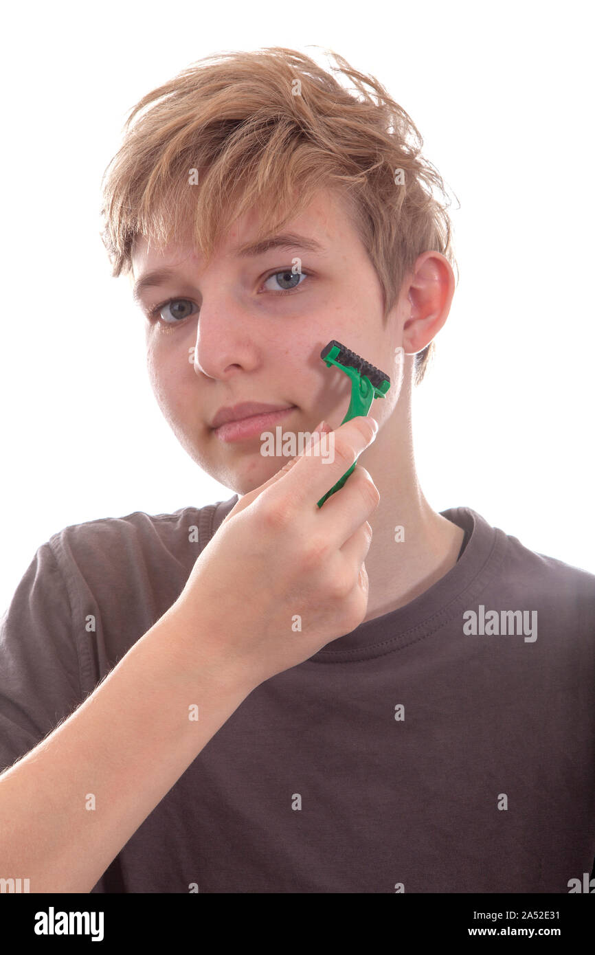 Transgender boy is shaving for the first time over white background ...