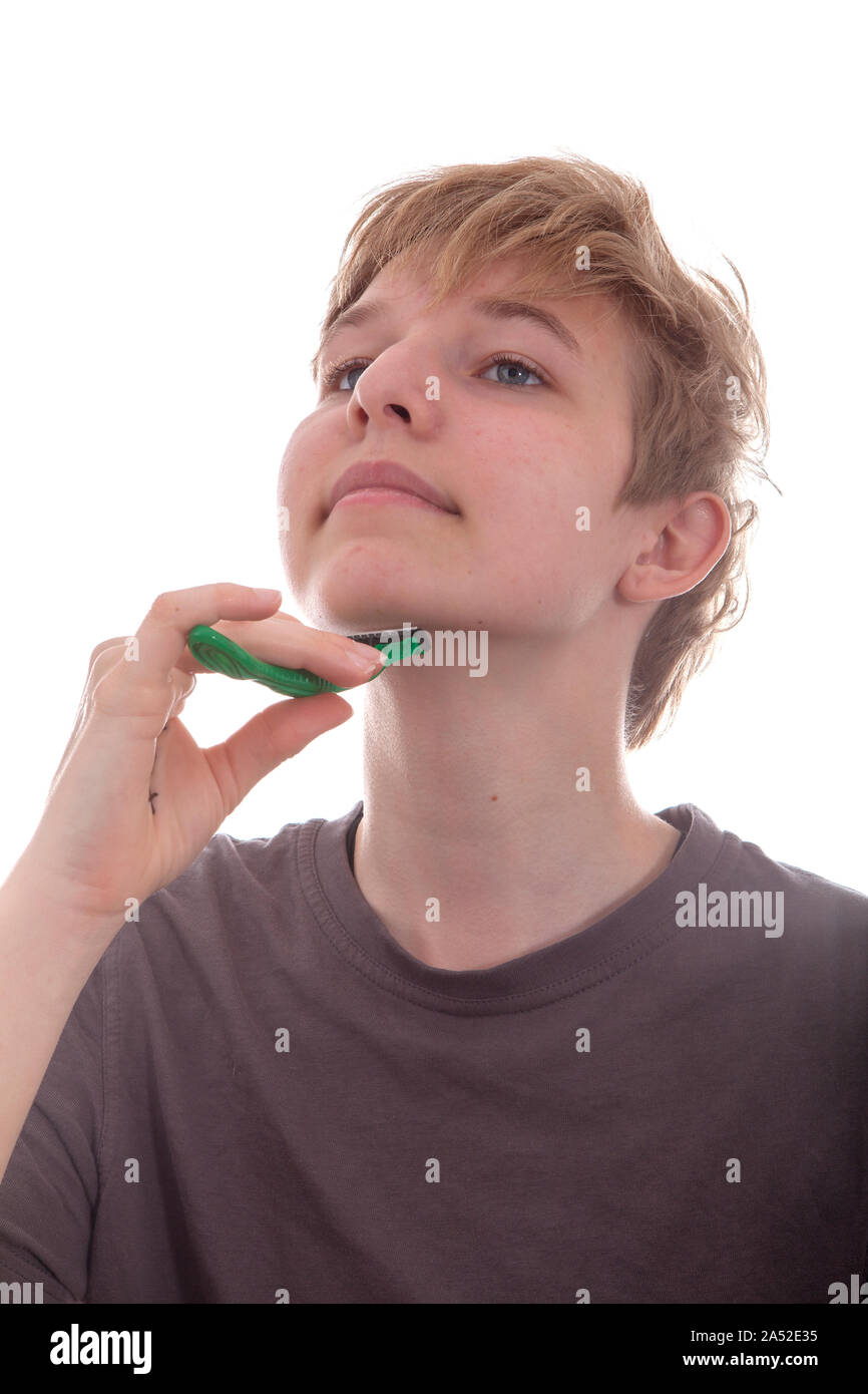 Transgender boy is shaving for the first time over white background ...
