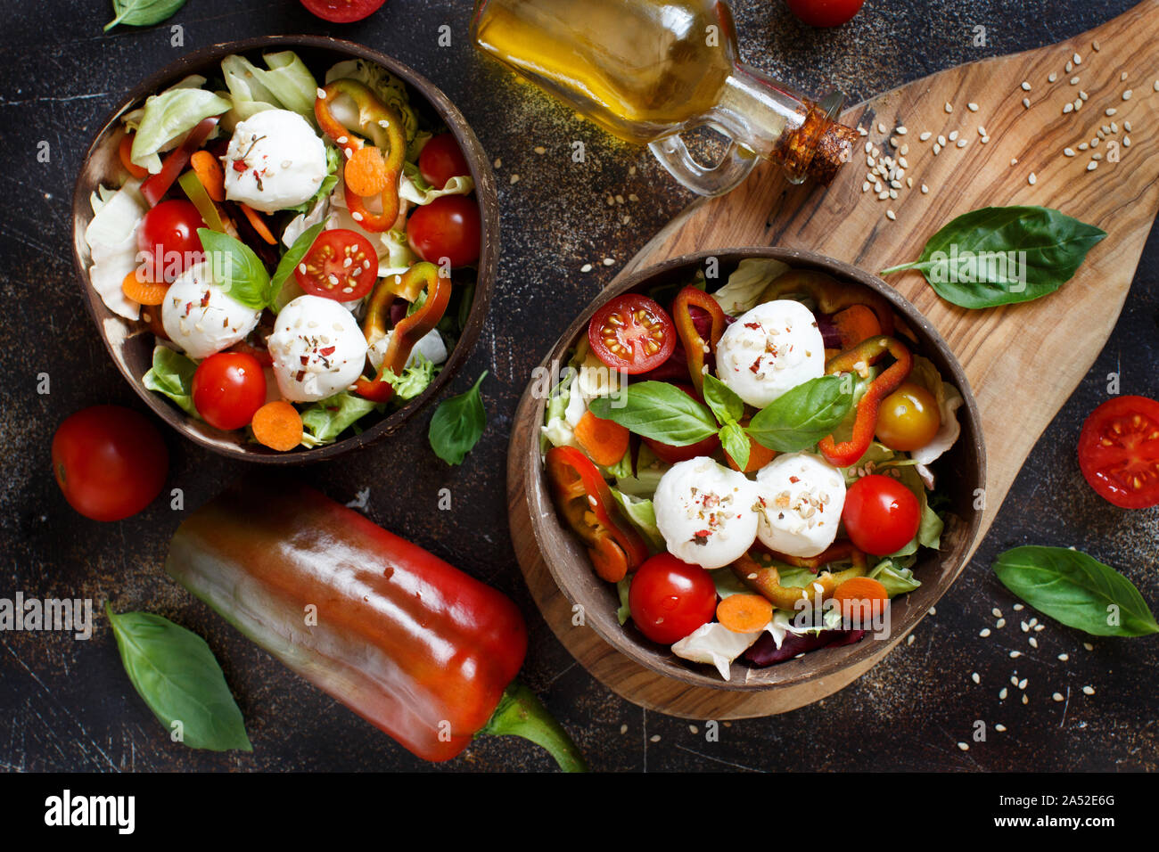 Mixed salad with mozzarella in coconut bowls close up Stock Photo - Alamy