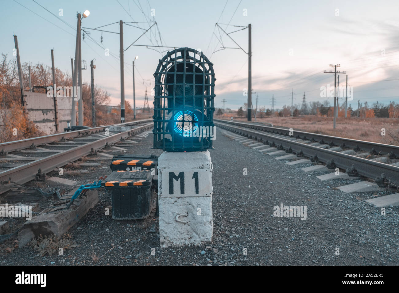 Blue railway traffic light on the background of rails Stock Photo - Alamy