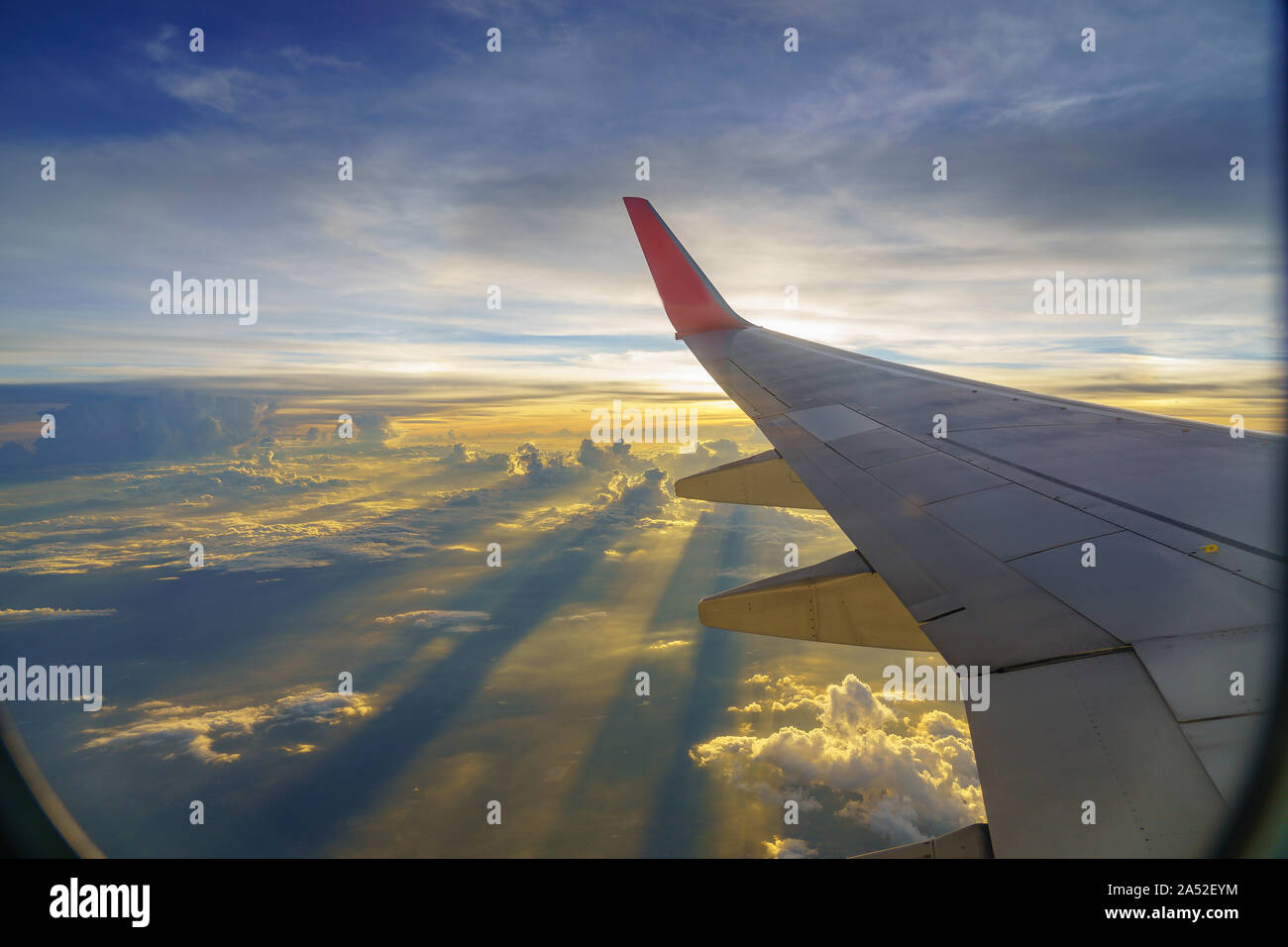 Beautiful sunset, sky on the top view, airplane flying view from inside ...