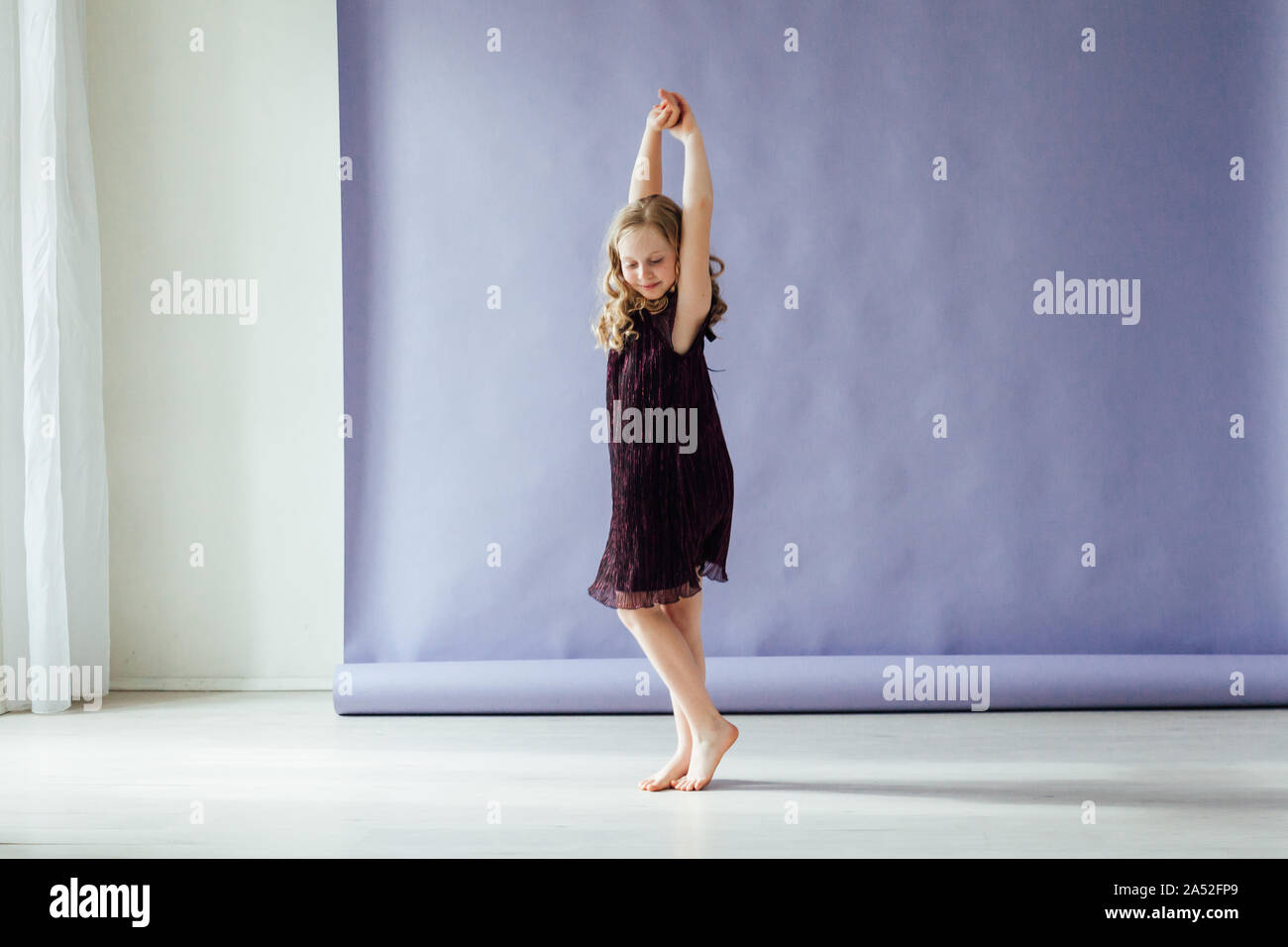 Beautiful blonde girl in dress dancing alone at home Stock Photo - Alamy
