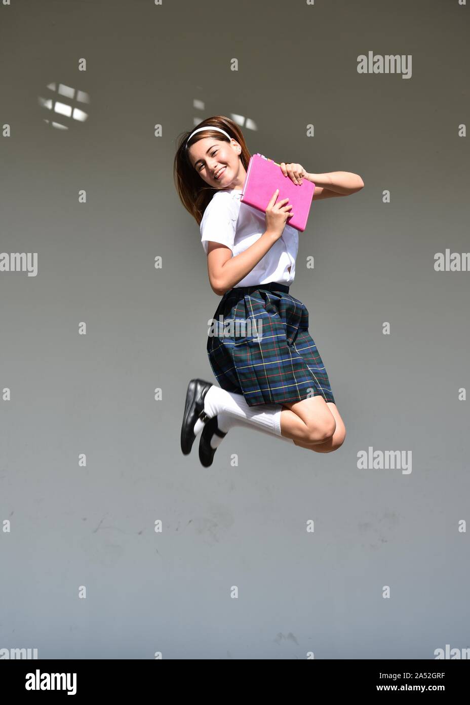 Happy Excited Girl Student Jumping Stock Photo - Alamy