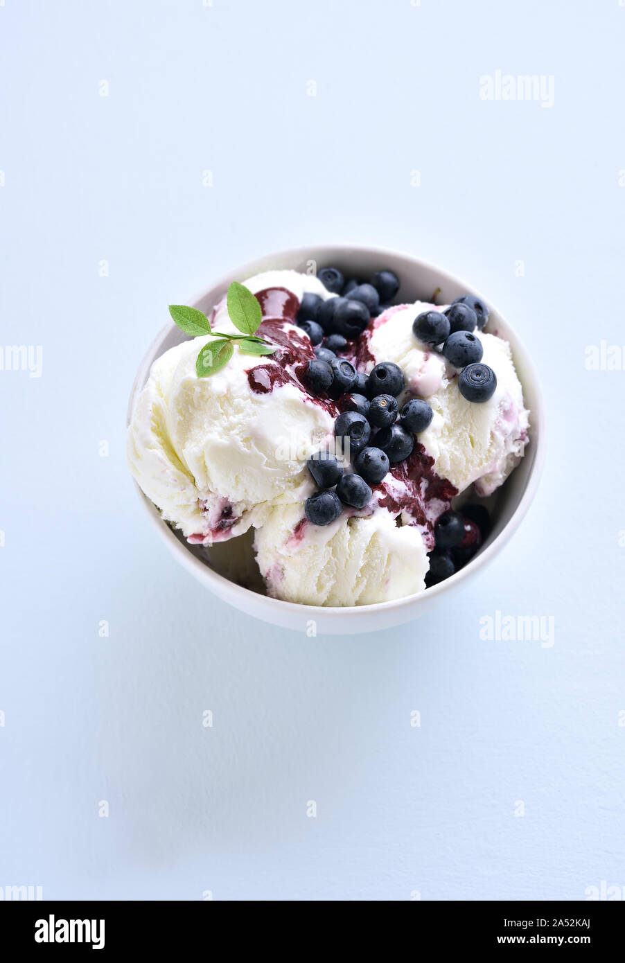 Blueberry ice cream in bowl on blue stone background with free space ...