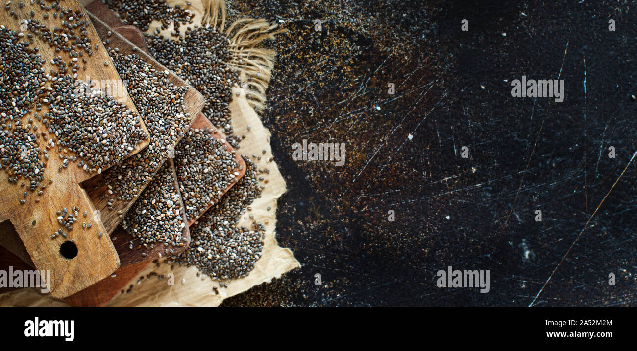 Chia seeds top view on a dark background Stock Photo - Alamy