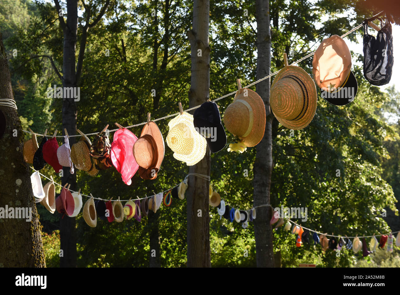 Summer hats hanging on a washing line Stock Photo - Alamy