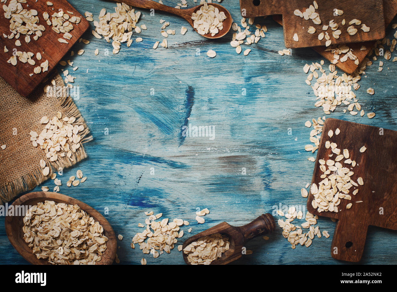 Rolled oats top view on a blue table with a copy space Stock Photo - Alamy