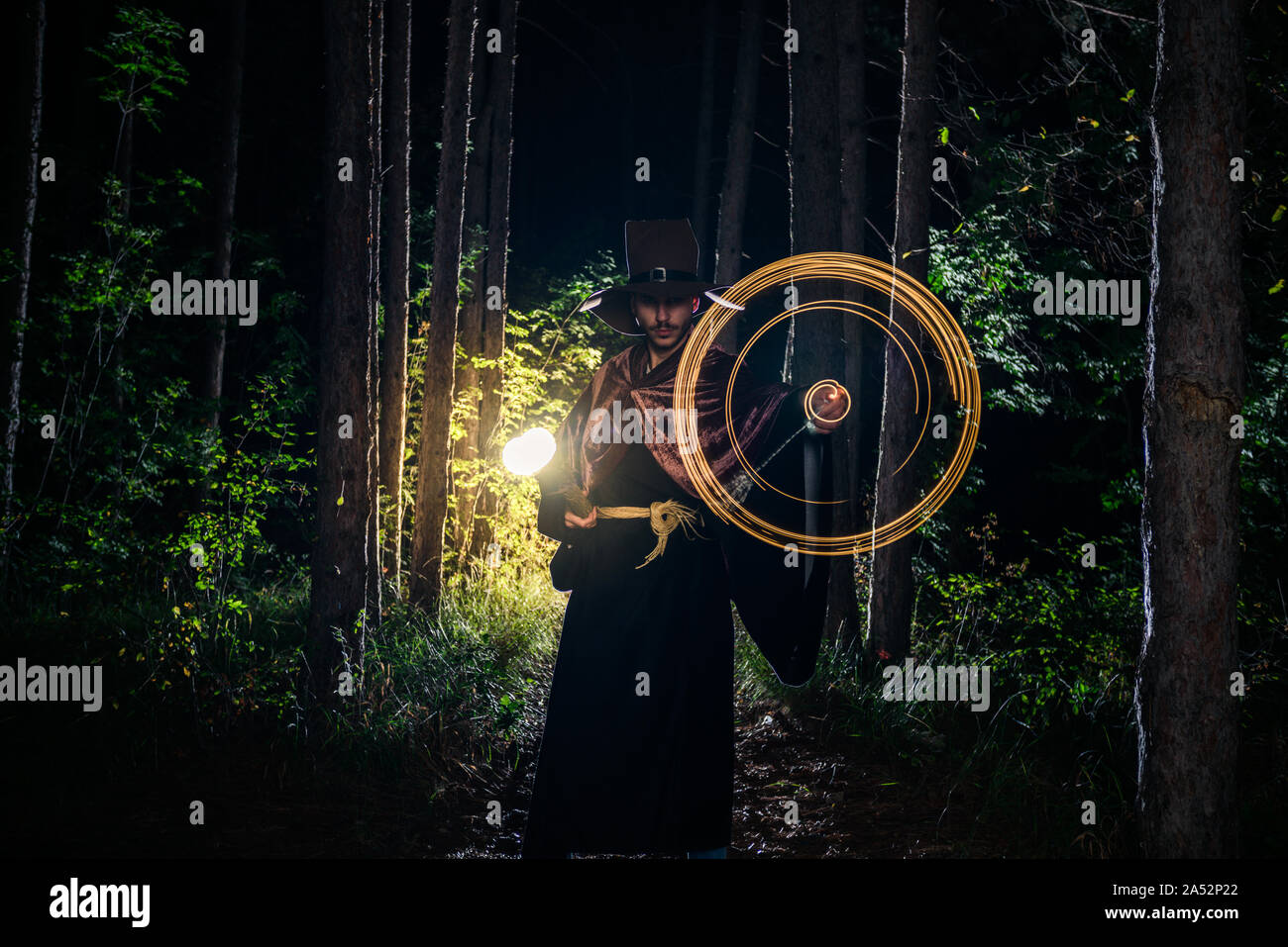 Male human wearing sorcerer costume performing spells with a magic ...