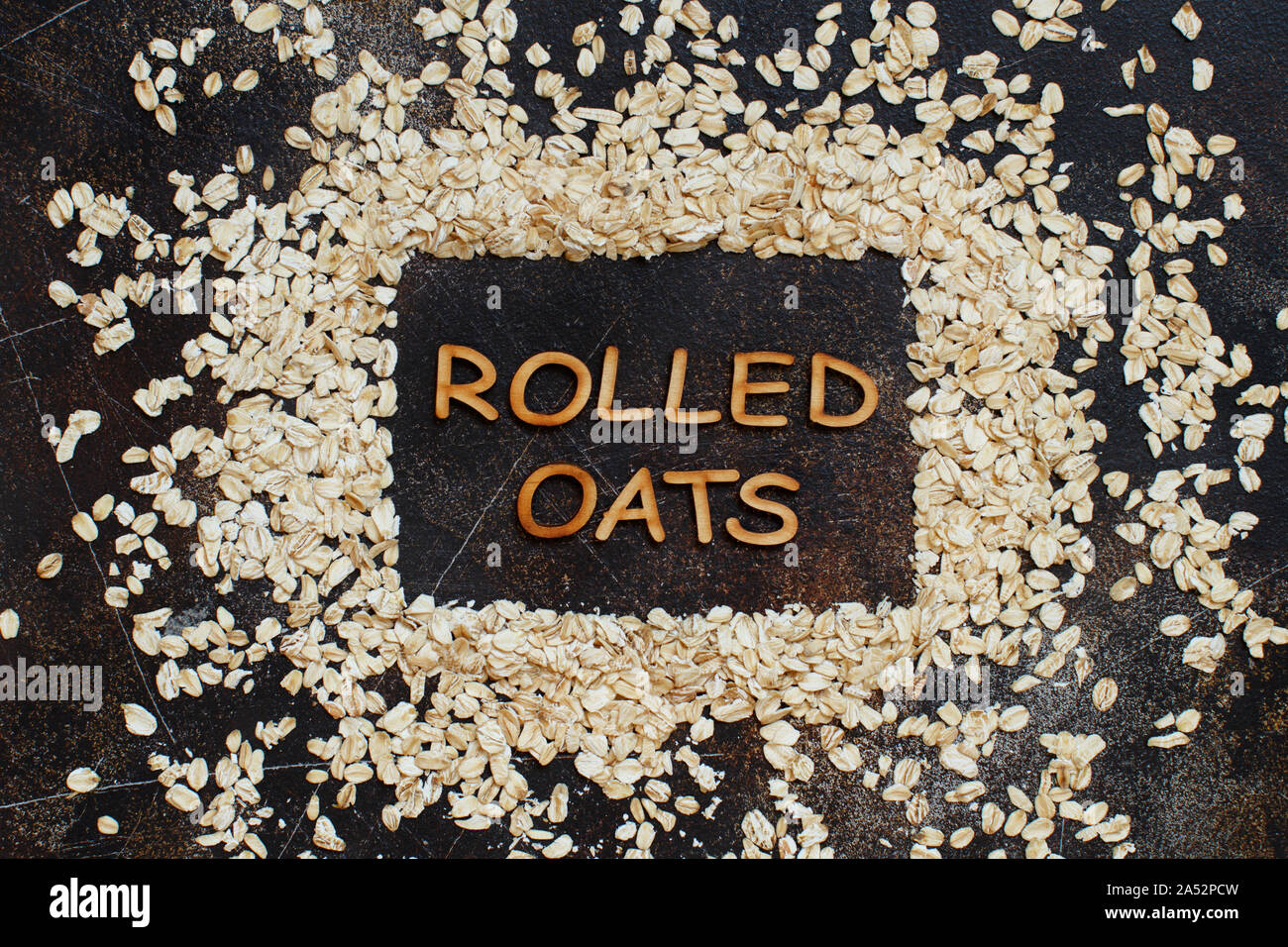 Rolled oats top view on a dark table with a word Rolled Oats Stock ...