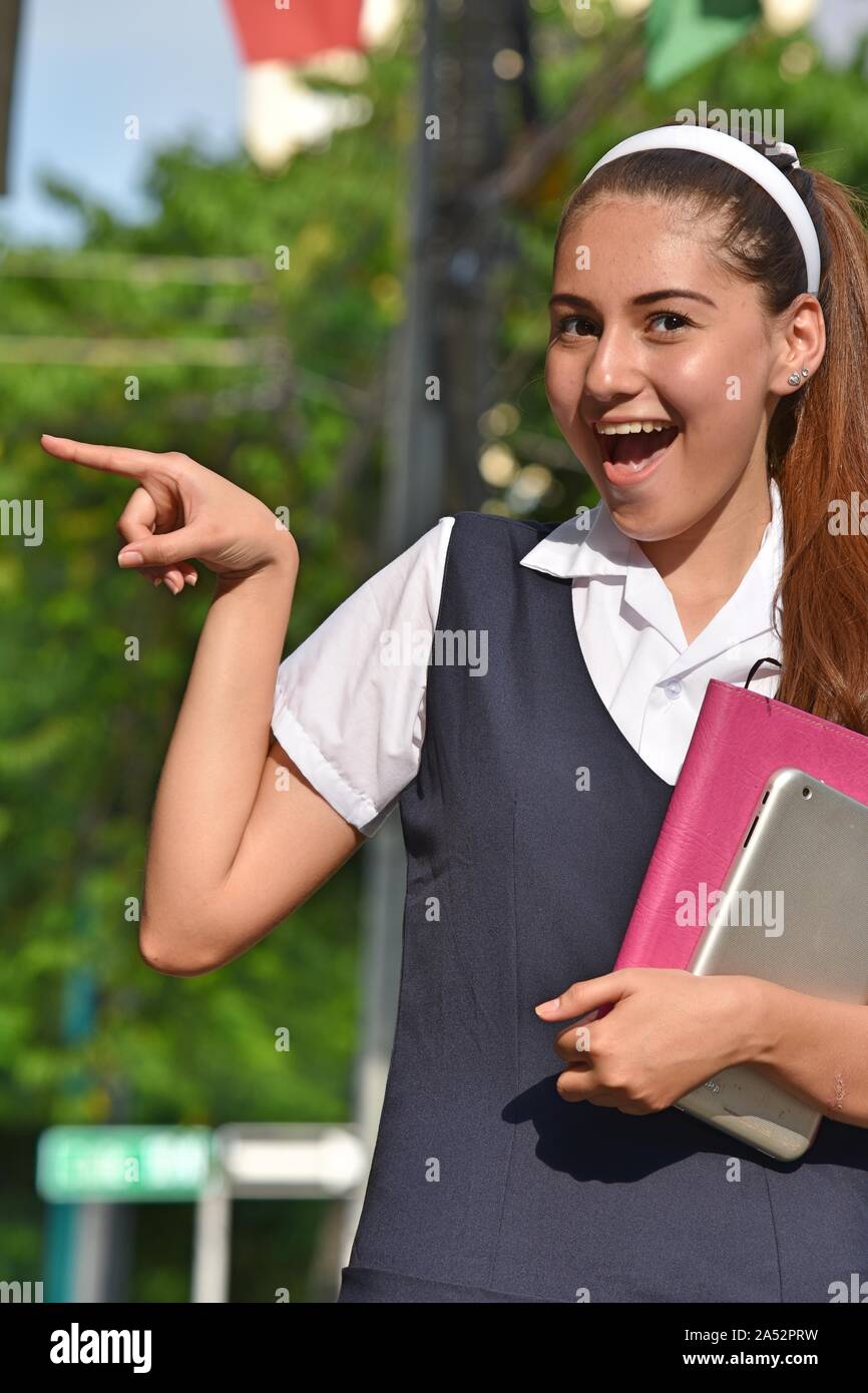Female Student Pointing With Books Stock Photo - Alamy