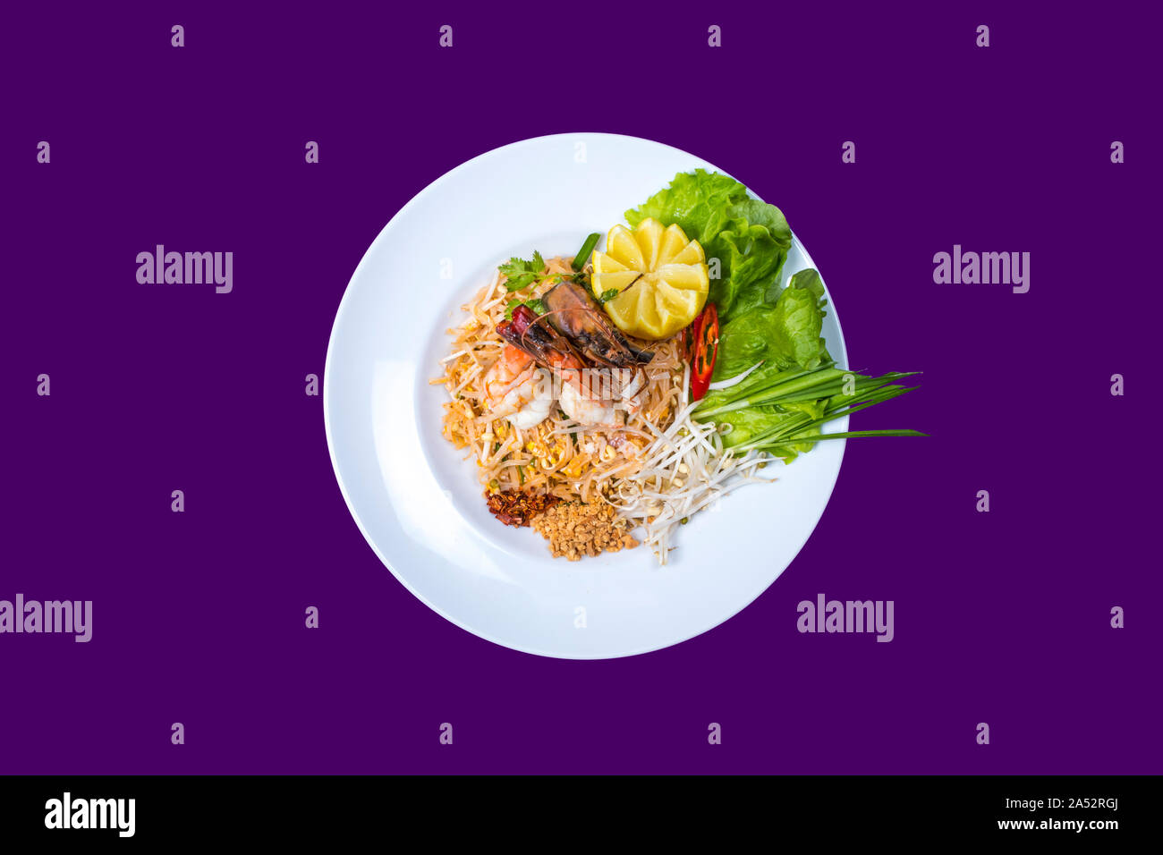 Asian Thai food on white plates with purple background with copy space ...