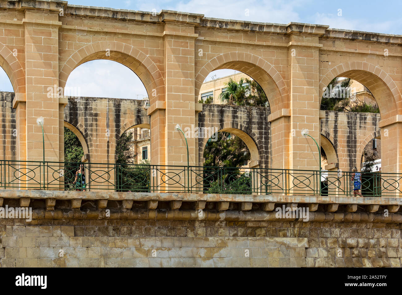 Golden limestone arches of side terrace of Upper Barrakka Gardens in ...