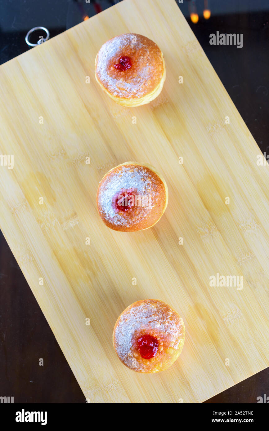Close up view of tasty Jelly Doughnuts with jam on wood background ...