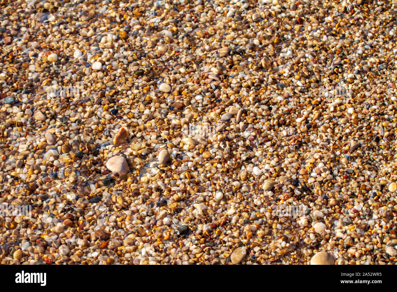 sea pebbles colored granite on the beach background stones. The shore ...