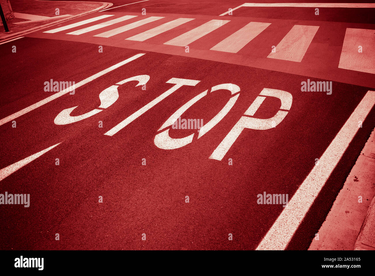 stop sign white paint on red street, pedestrian crossing on the top of ...