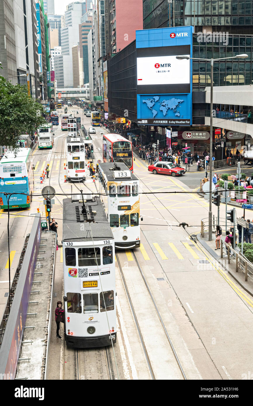 Historic double decker trams travel down Des Voeux Road in the central ...