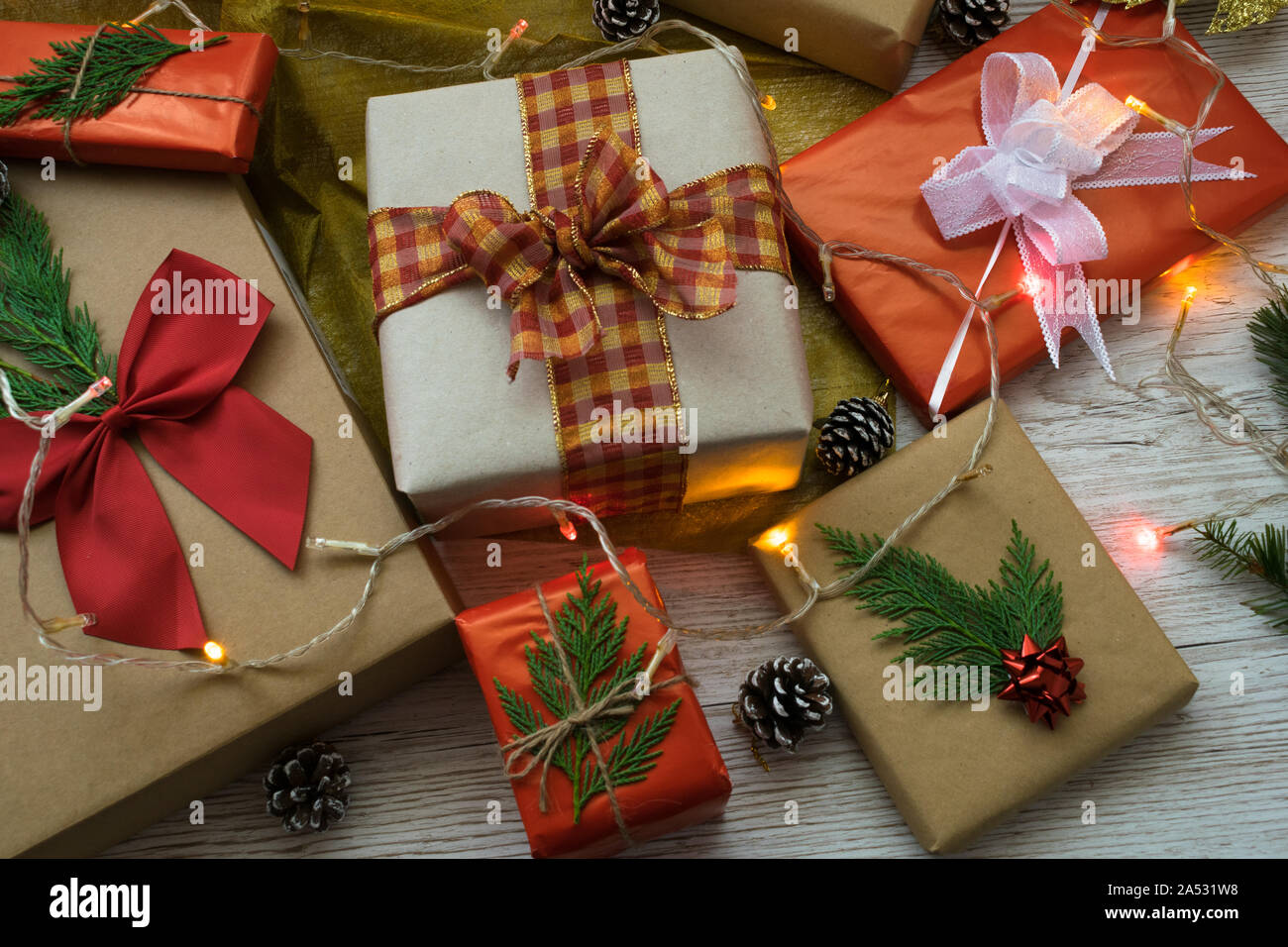 Christmas gift box with lights on a wooden table Stock Photo - Alamy