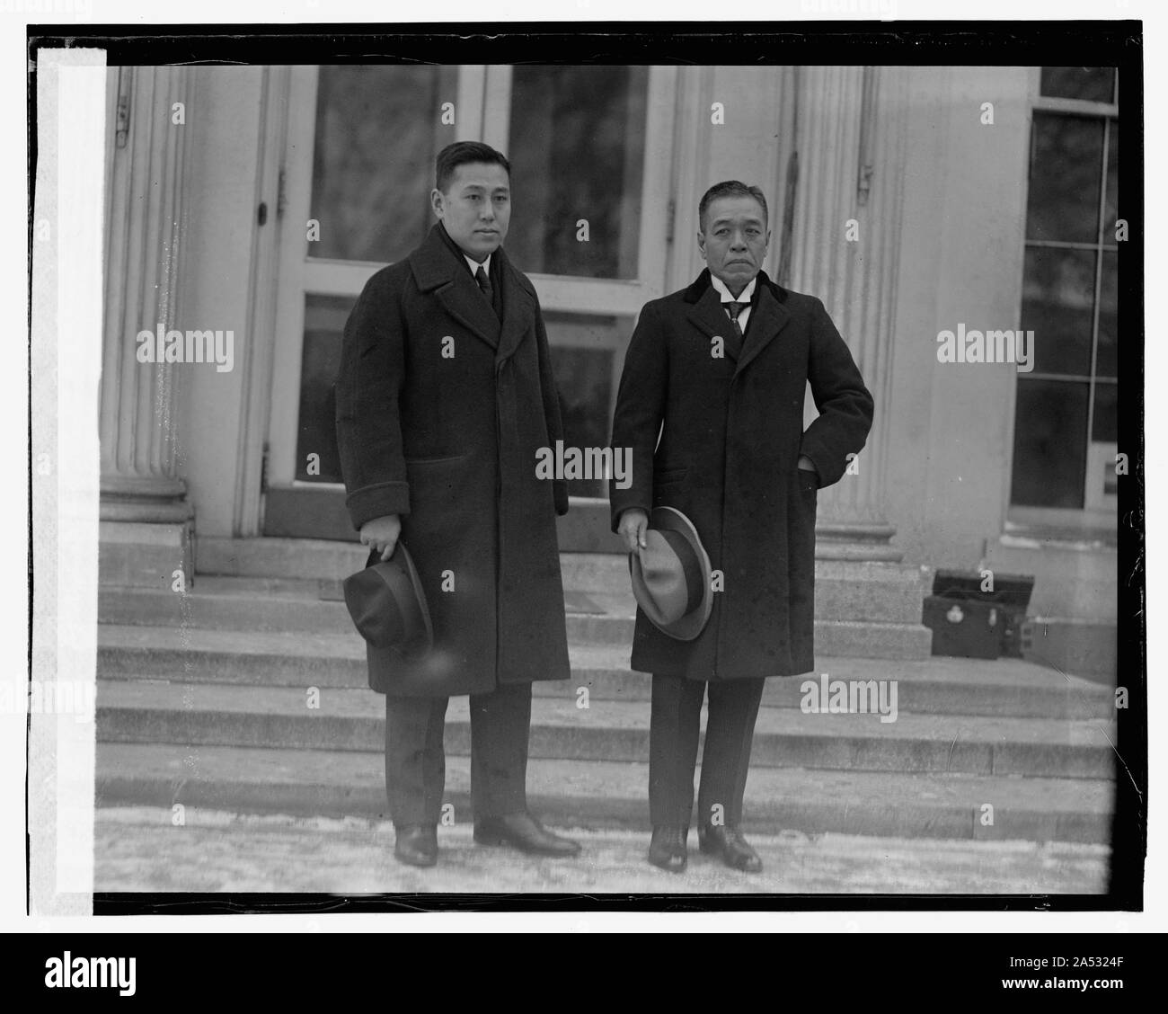 Two men standing by steps of building Stock Photo - Alamy