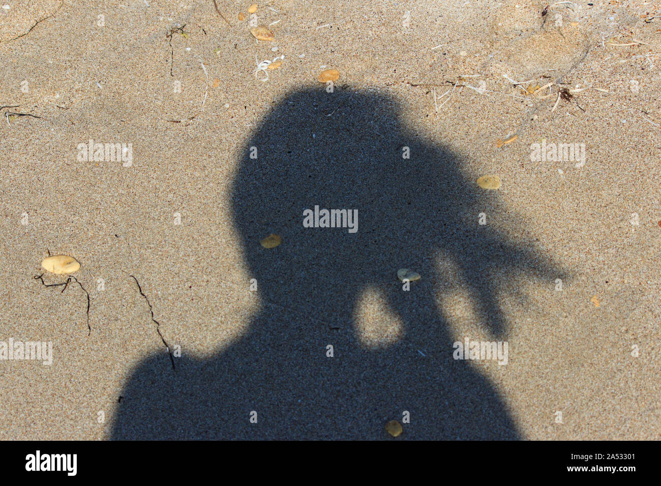 shadow of a girl on the background of the oncoming sea wave. Sandy ...