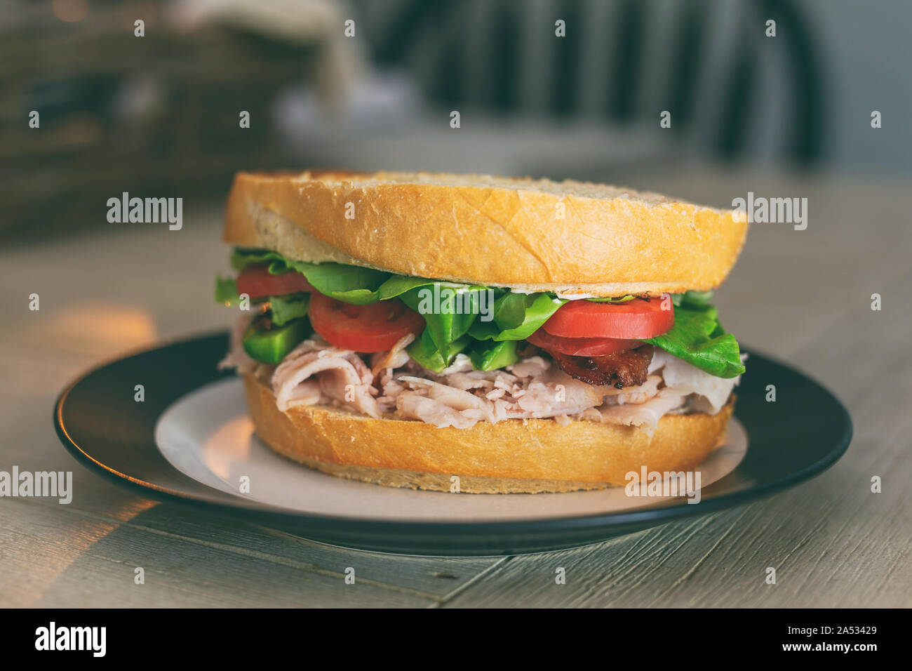 Whole turkey club sandwich with avocado and bacon on freshly baked ...