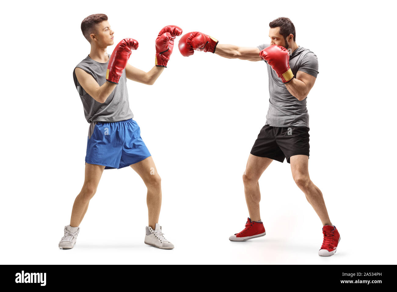 Full length shot of two young men training box isolated on white ...