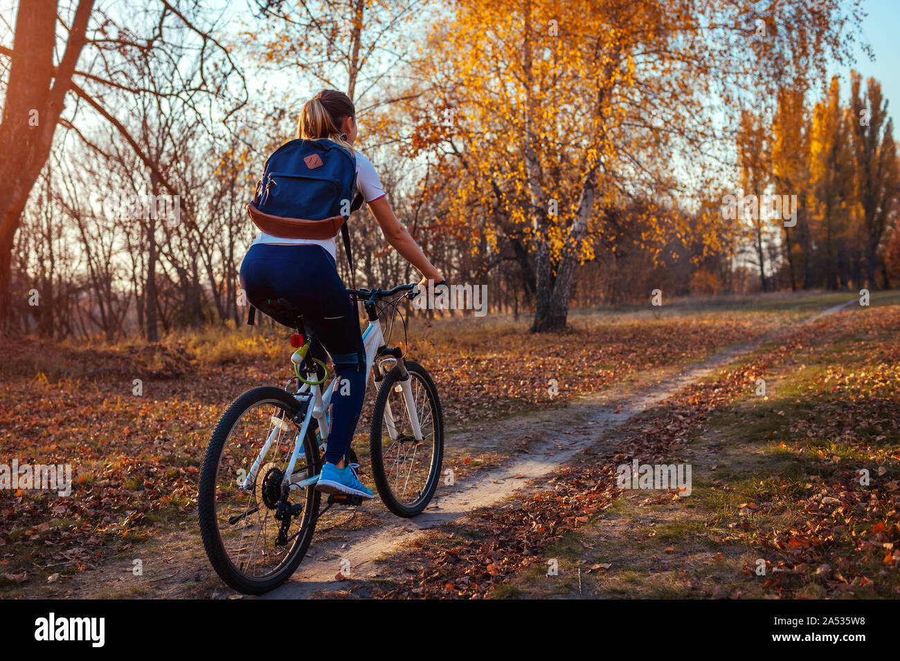 Girl riding bicycle backpack hi-res stock photography and images - Alamy