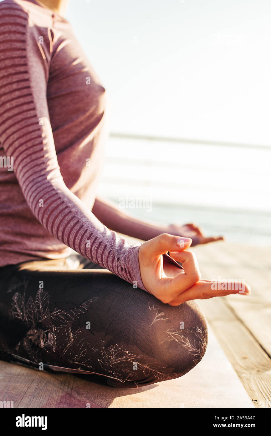 Woman meditating in the Lotus position Stock Photo - Alamy
