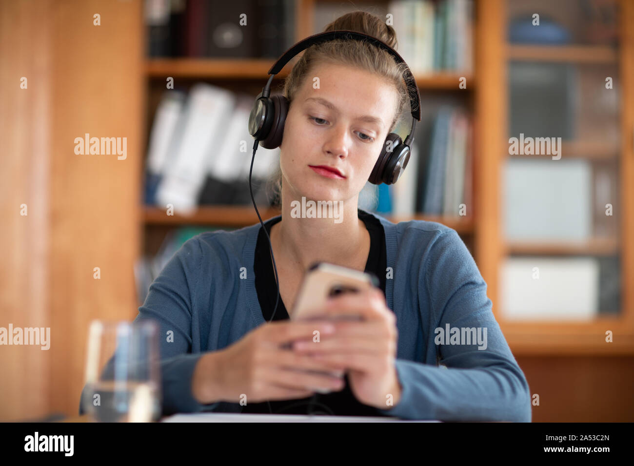 student learning in a library with headphone Stock Photo - Alamy