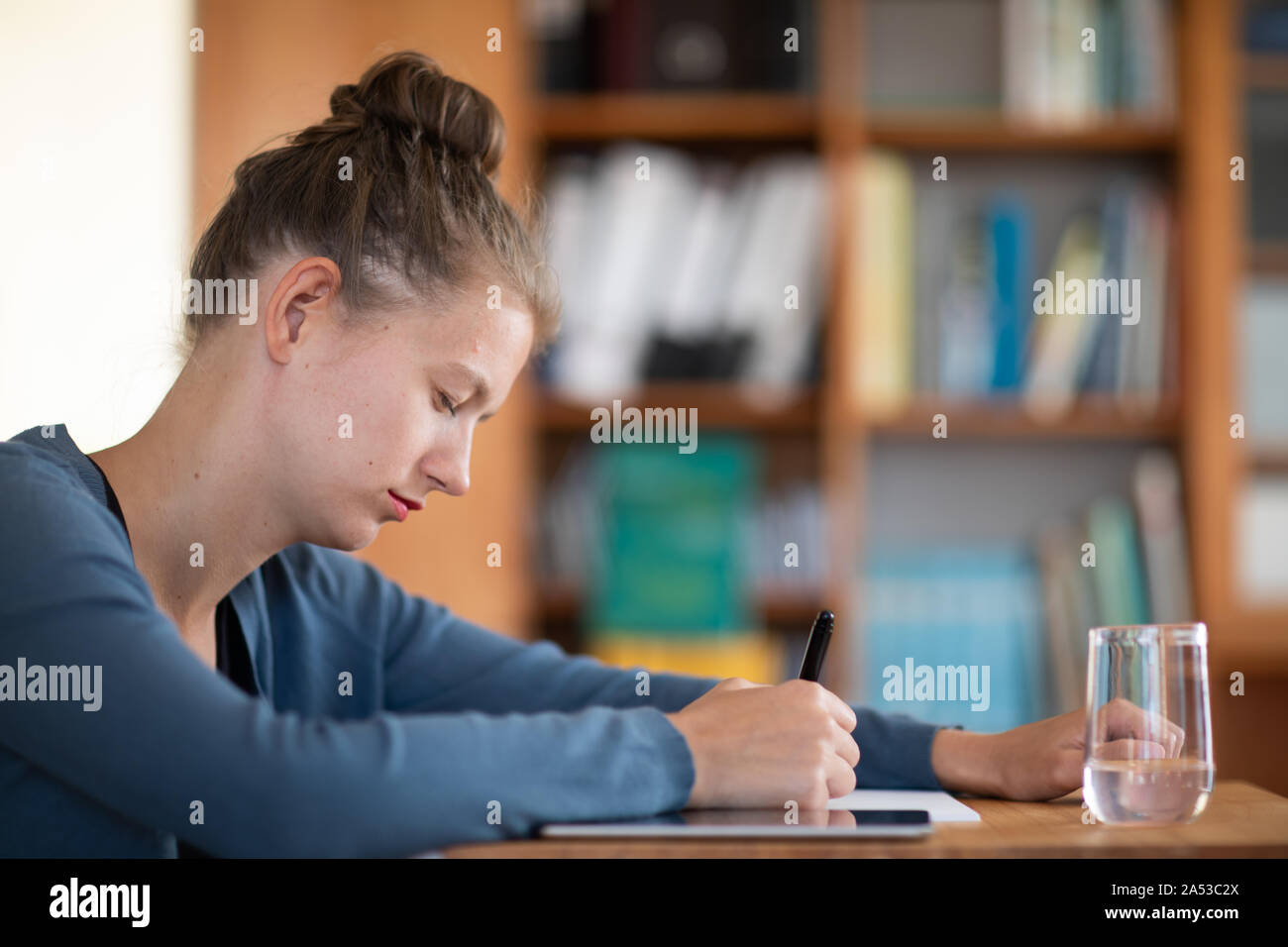 student learning in a library Stock Photo - Alamy