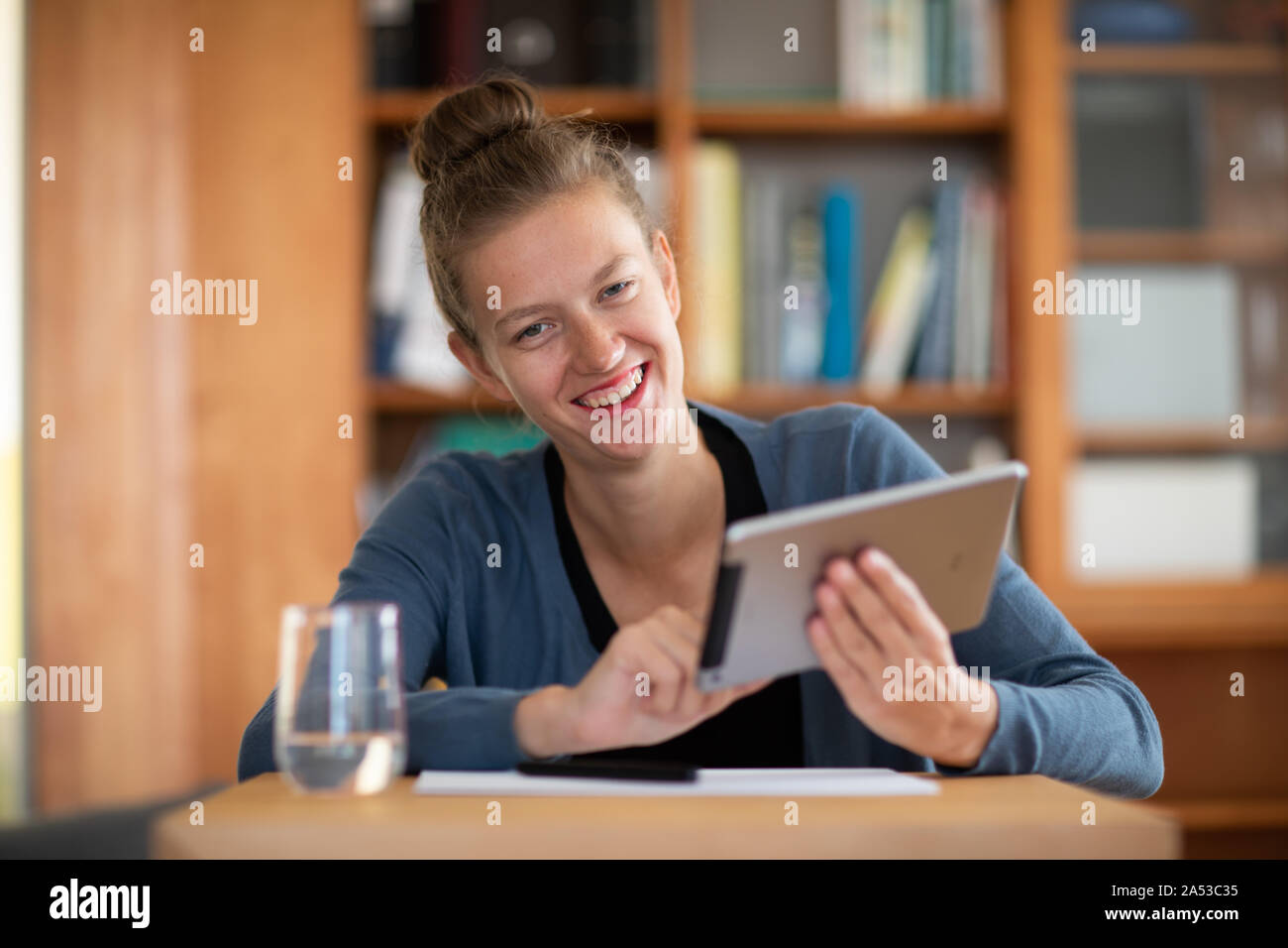 student learning in a library with tablet Stock Photo - Alamy