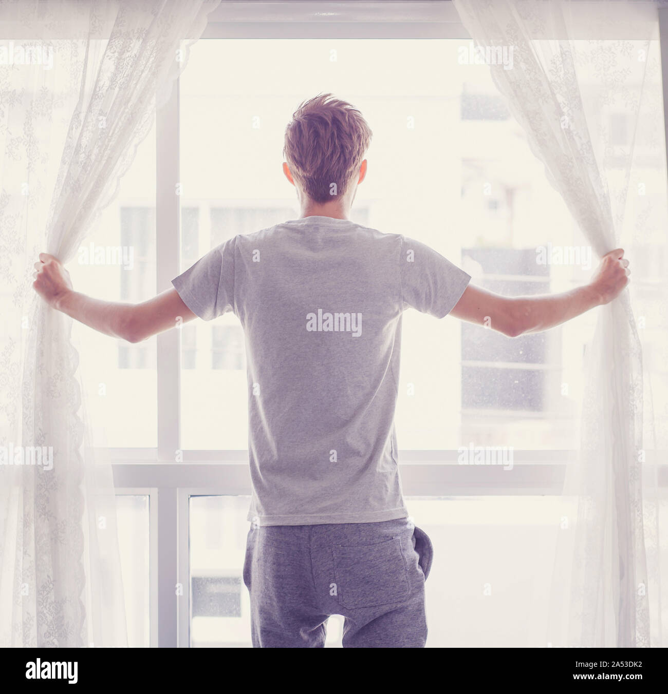 Man opening curtains hi-res stock photography and images - Alamy