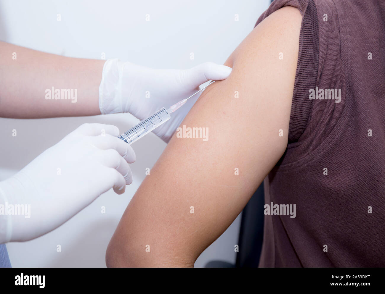 Close-up Of Doctor Injecting Patient With Syringe To Collect Blood ...