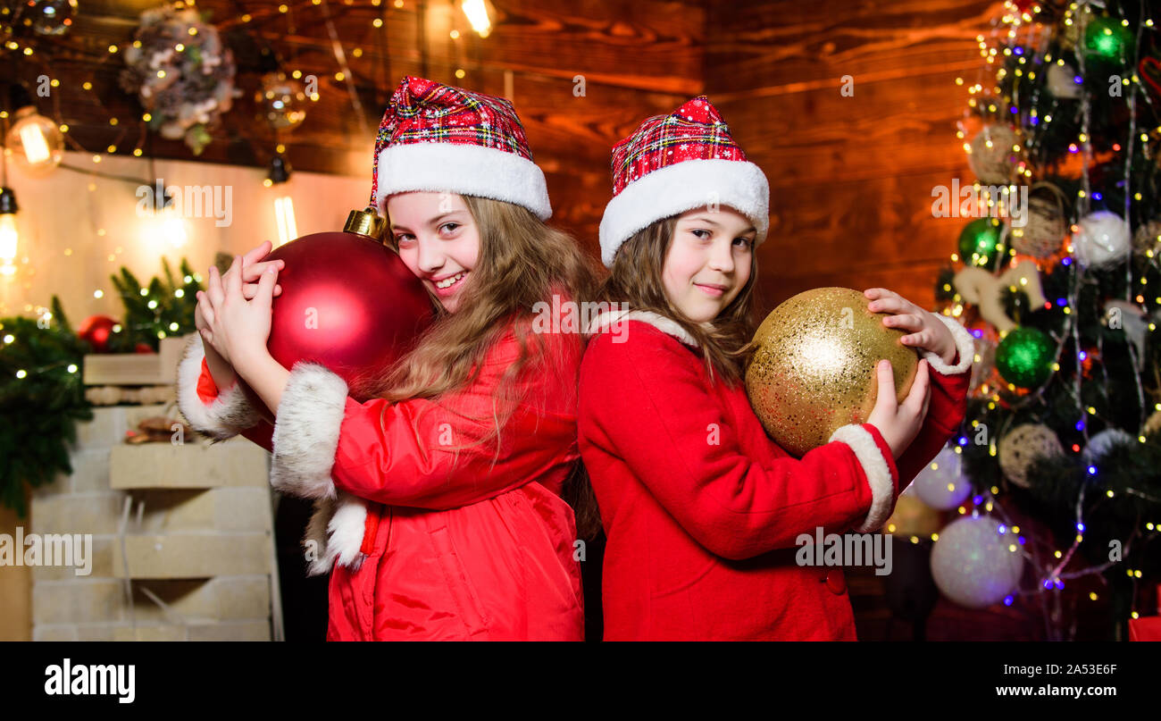 Togetherness concept. Decorate christmas tree together. Girls sisters ...