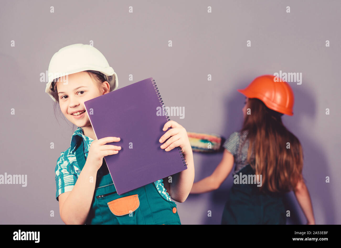 Children sisters renovation their room. Control renovation process ...