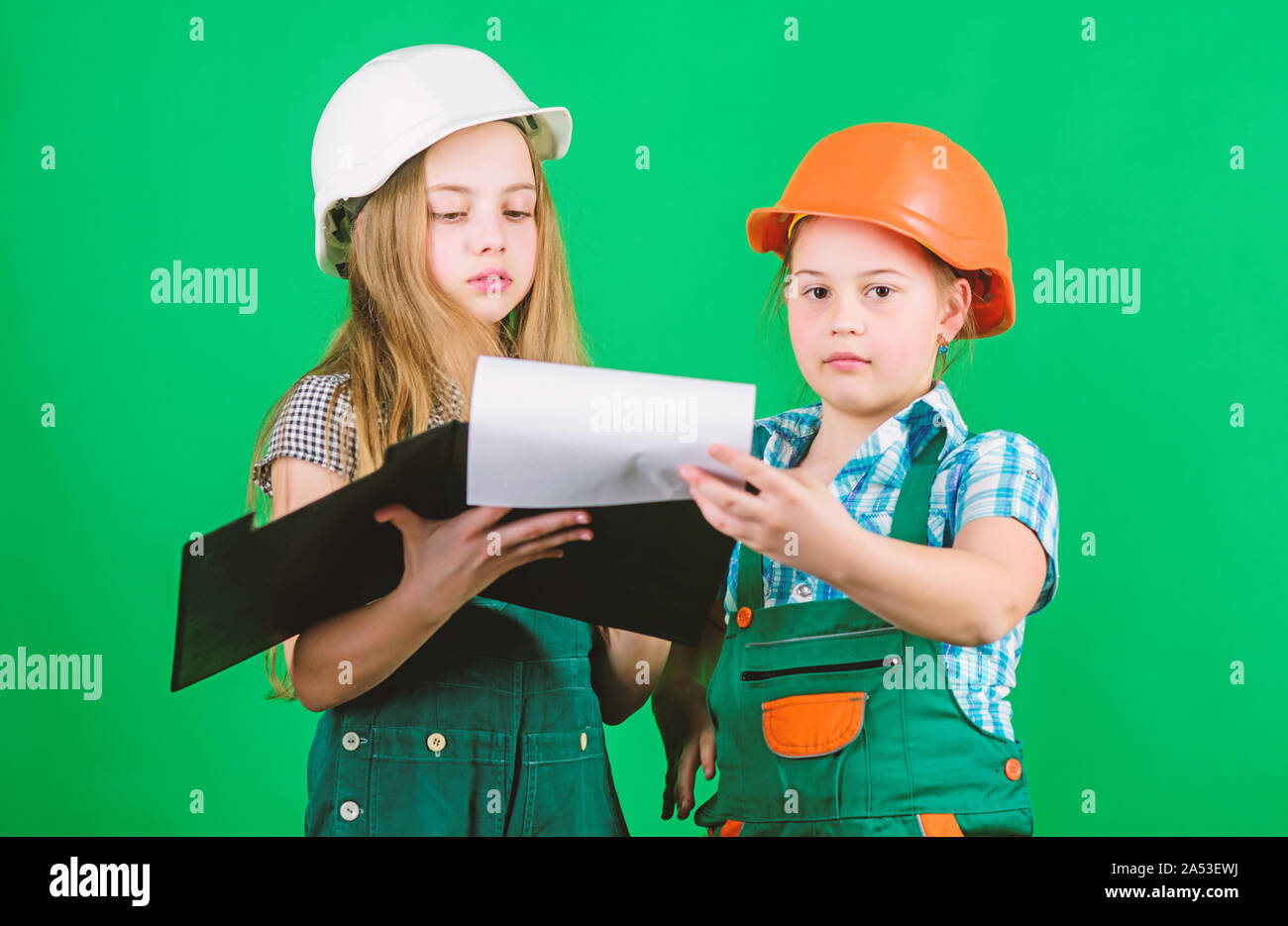small girls repairing together in workshop. school project. Happy ...