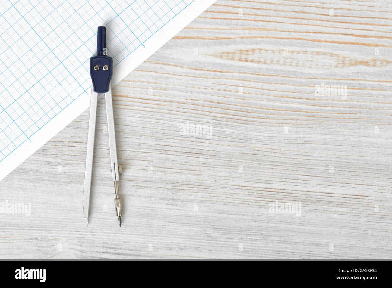 Compass on graph paper in top view with copy space Stock Photo - Alamy