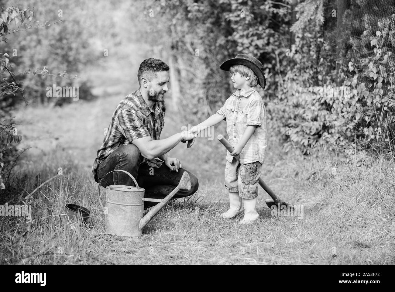 father and son in cowboy hat on ranch. happy earth day. Family tree ...