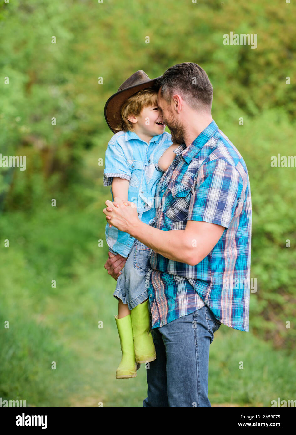 Child having fun cowboy dad. Farm family. Holidays at parents farm ...