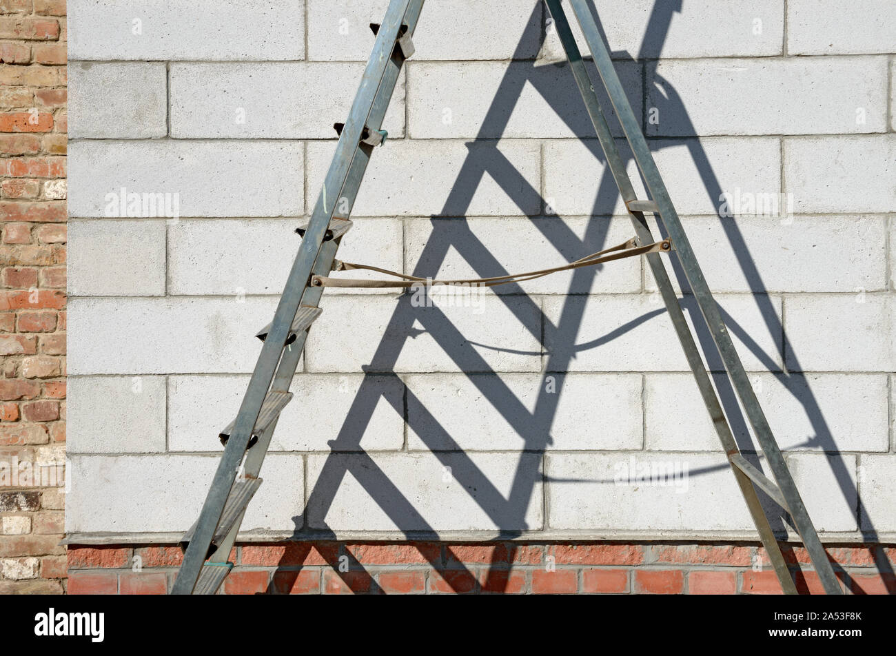 Close-up middle part of old used metal dismountable scaling ladder on ...