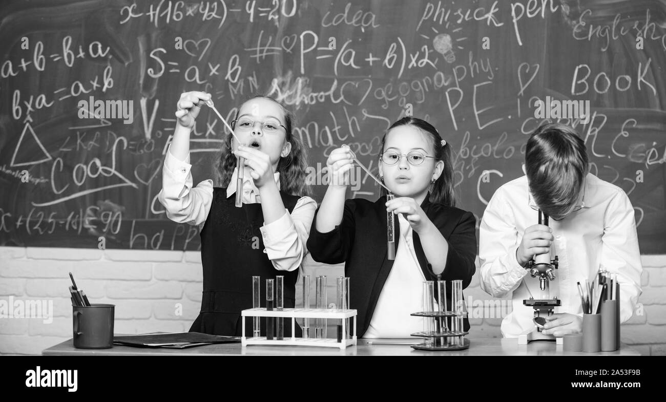 Little children at school lesson. students doing experiments with ...